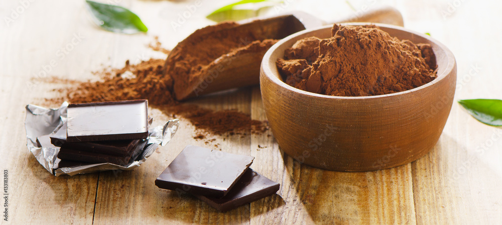 Chocolate bars and a bowl of cacao powder. Stock Photo | Adobe Stock