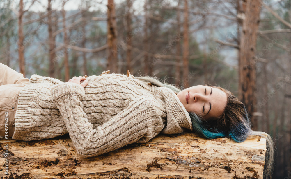Woman lying on tree trunk Stock Photo | Adobe Stock