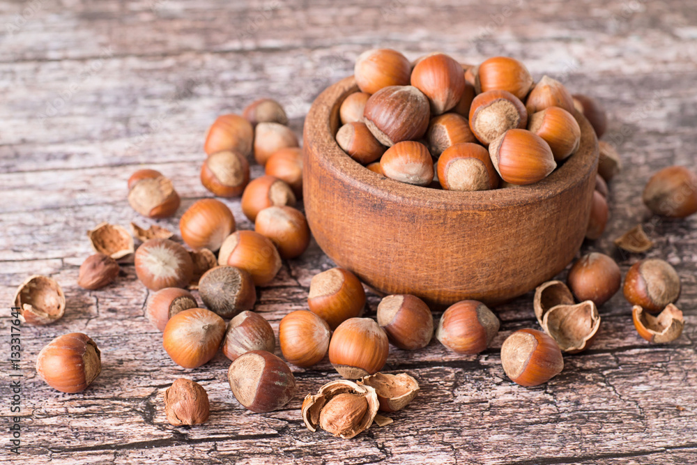 Nuts filbert. Nuts filbert, whole and peeled, in a brown wooden bowl on ...