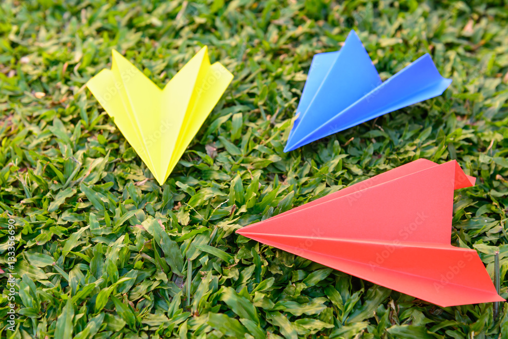 paper airplanes laying on grass background Stock Photo | Adobe Stock