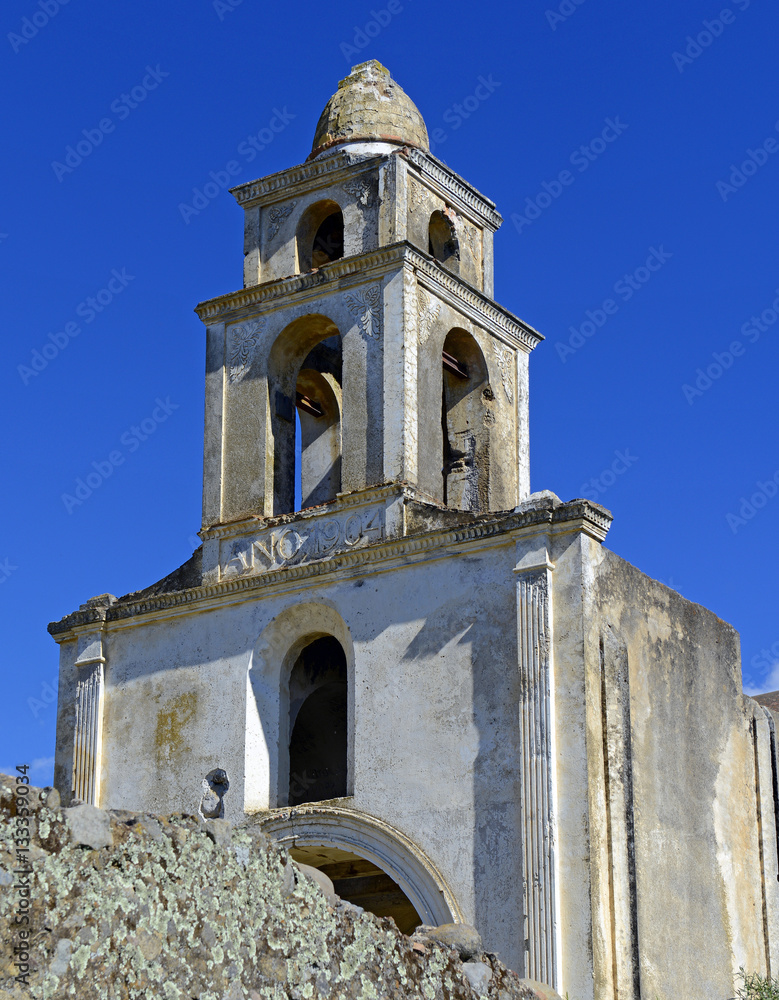 Old abadoned vintage cement church in field near rural village in ...