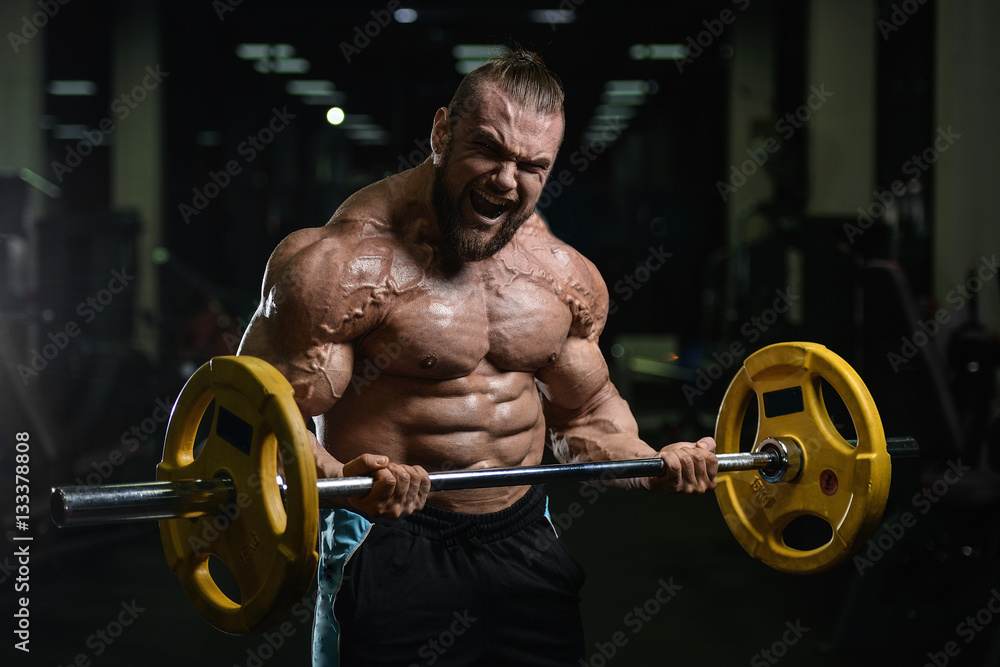 Brutal strong bodybuilder athletic men pumping up muscles with d Stock ...