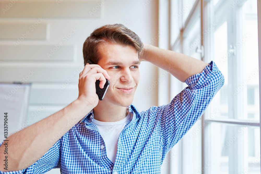 Junger Mann telefoniert mit Smartphone Stock Photo | Adobe Stock