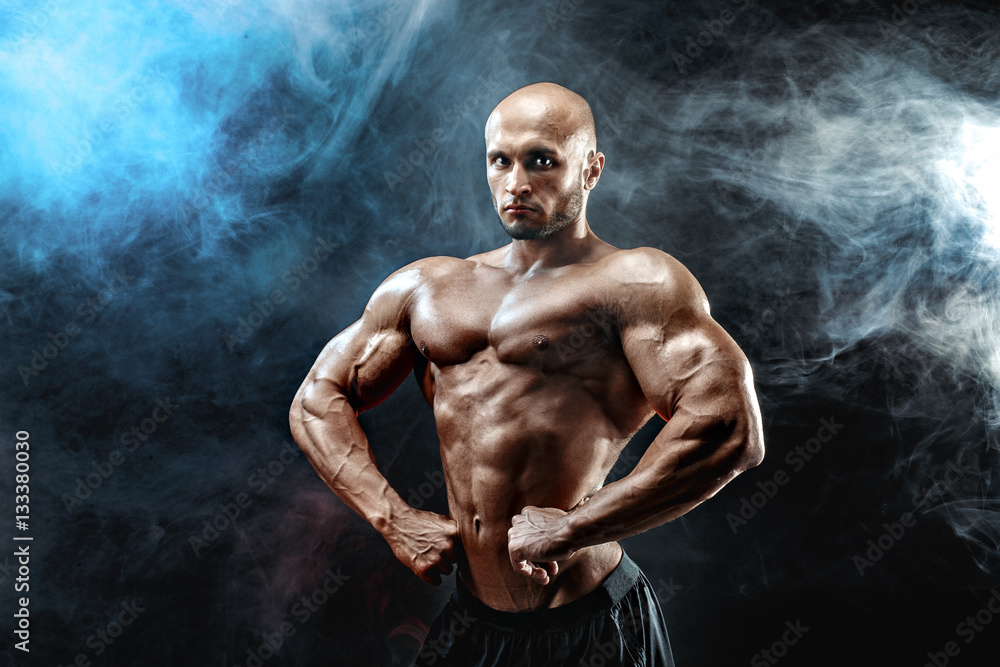 Strong bald bodybuilder with six pack. Bodybuilder man with perfect abs ...