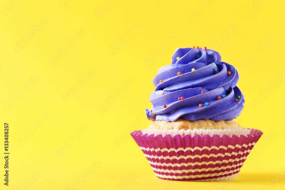 Tasty cupcake on a yellow background Stock Photo | Adobe Stock