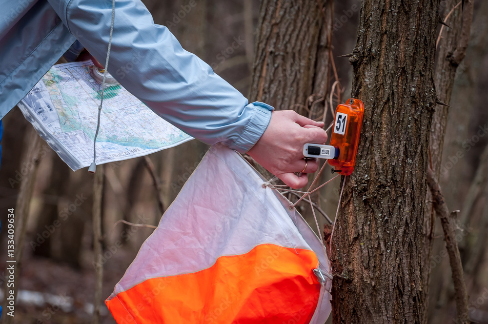 Orienteering. Chip system to mark a checkpoint. Man marks the ...