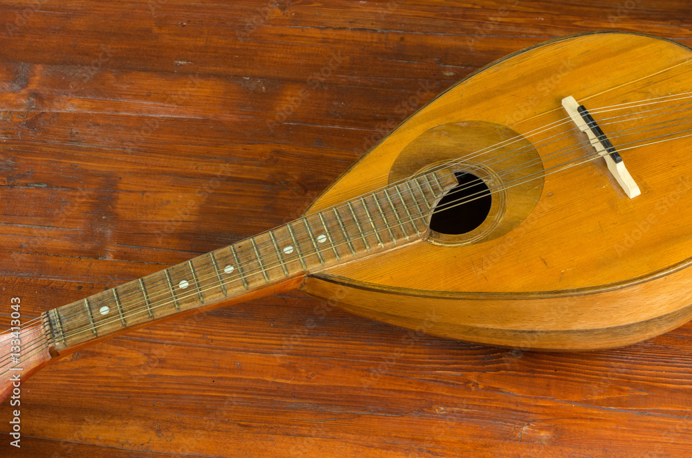 Mandolin on the background of painted wood, old musical instrument ...