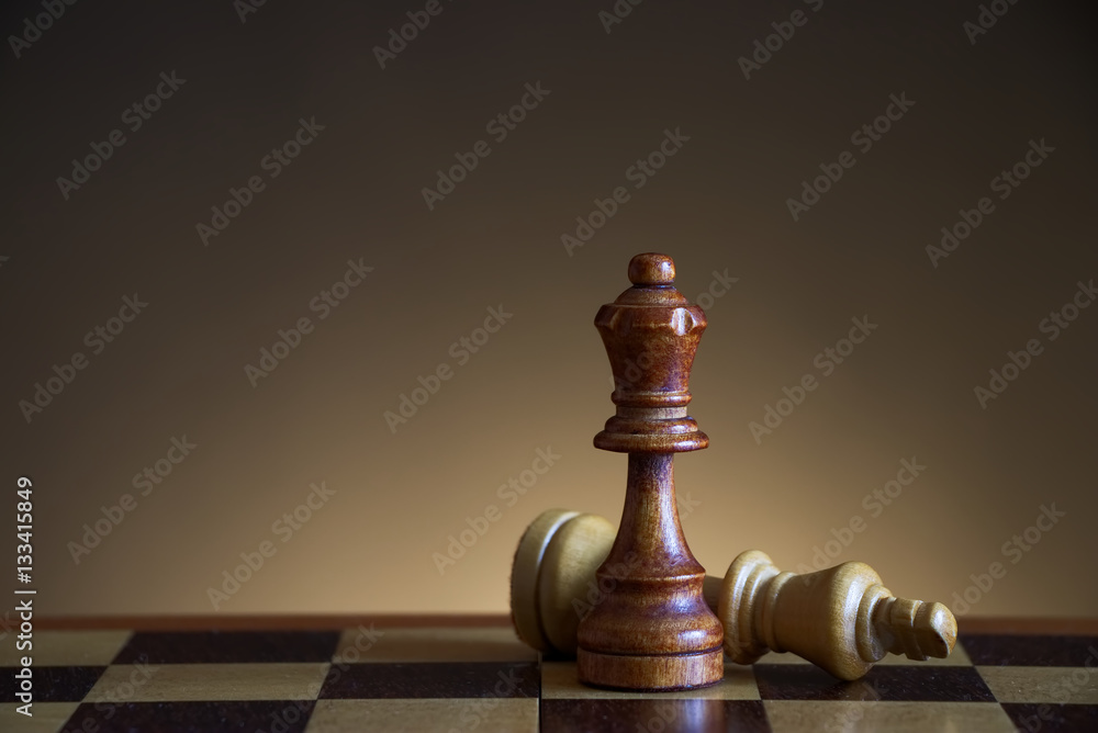 Dark queen defeats king in chess game, symbol of victory on the ...