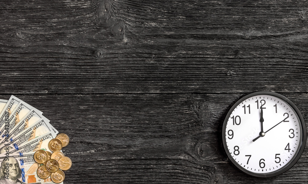 Clock with money on black wooden background. Time is money. Stock Photo ...