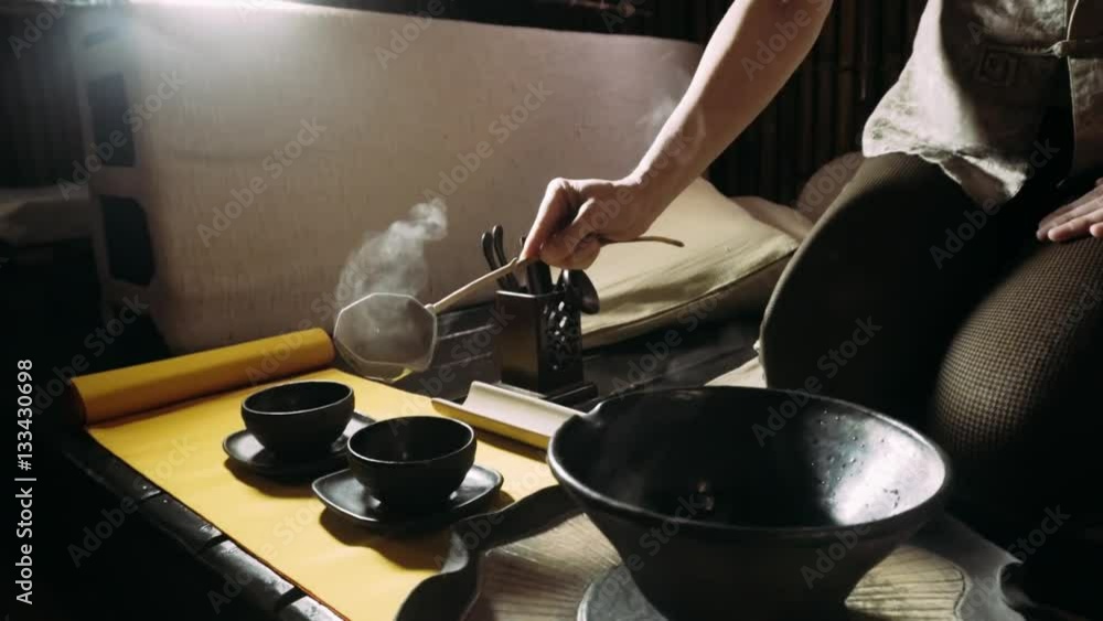 Pouring tea with the help of ladle.Tea ceremony. Brewing tea in the ...