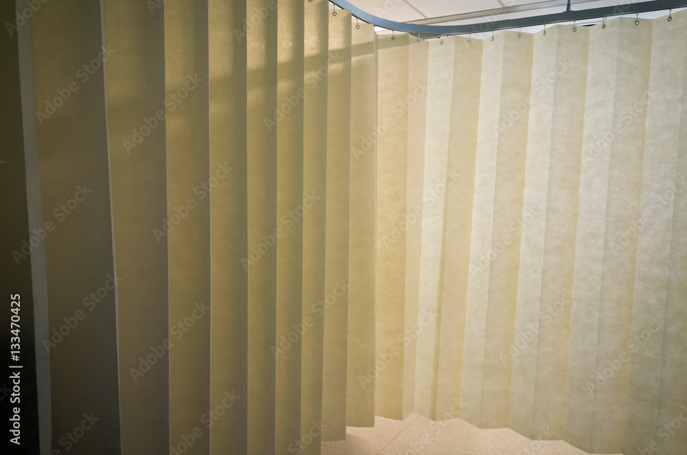 Hanging dividing curtain in a hospital ward. Folding room divider ...