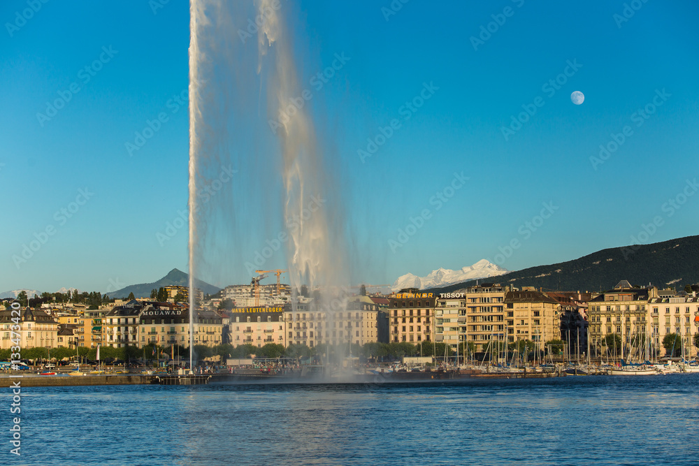 The moon rises over Mont Blanc and Geneva as the geyser sprays into the ...