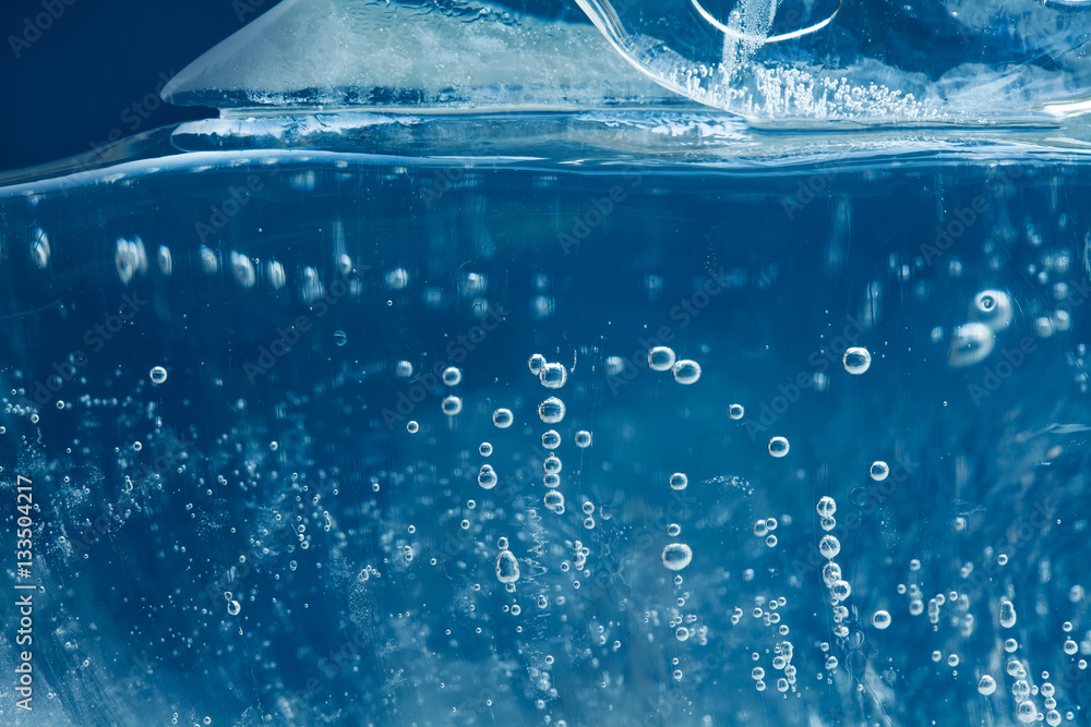 Ice texture with frozen air bubbles. Blue icy surface macro view, soft ...