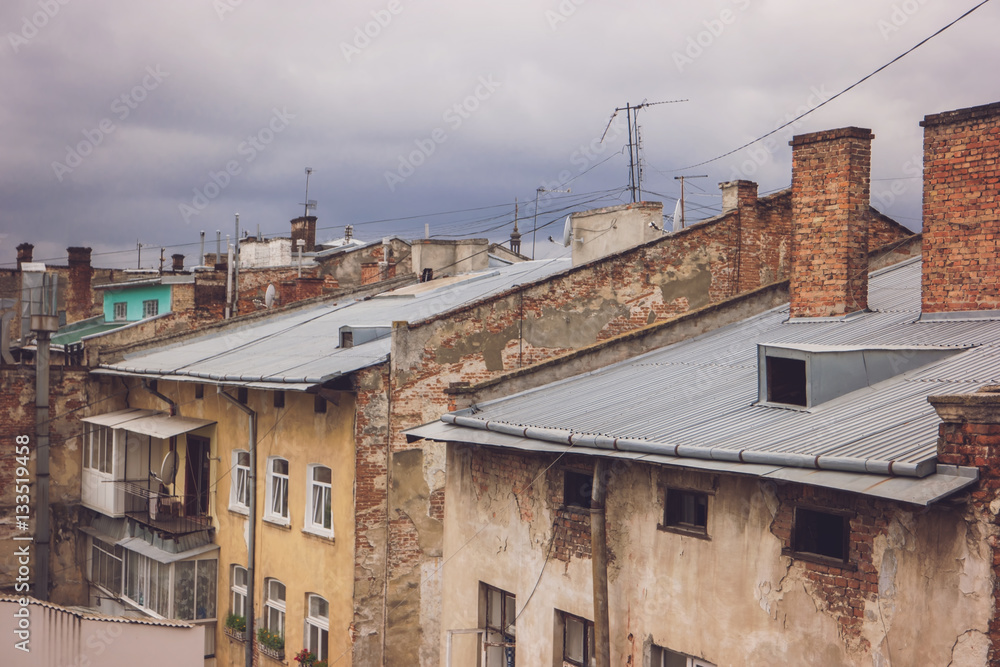 Old brick buildings. Rooftops and gloomy sky. Every street has its ...