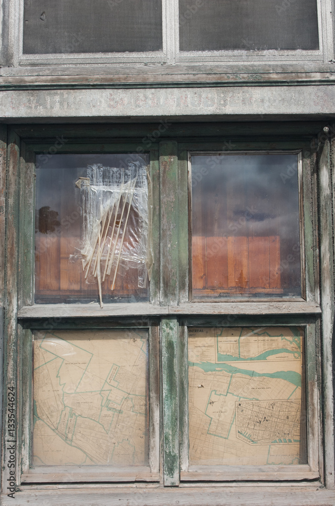 Broken window from a rock thrown at it, taped up. Broken window in an ...
