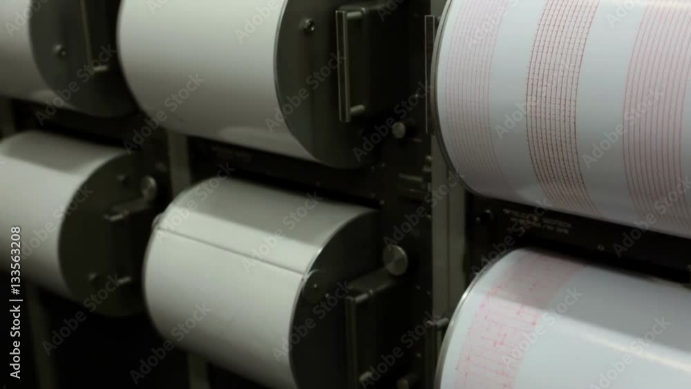 Seismograph records an earthquake on the sheet of measuring paper ...