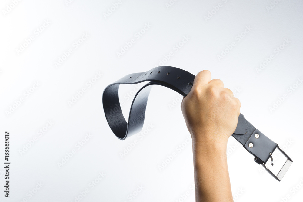 Hand holding leather belt for punishment, family violence conce Stock ...