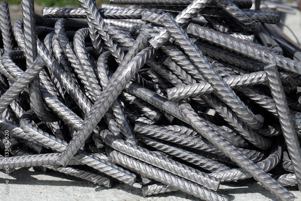 bent division rebar - closeup of a pile of curved steel bars bundled ...