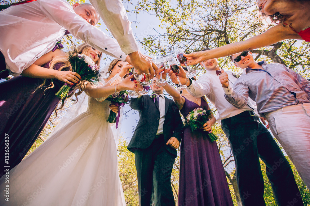 bride and groom with happy groomsmen and bridesmaids having fun and ...