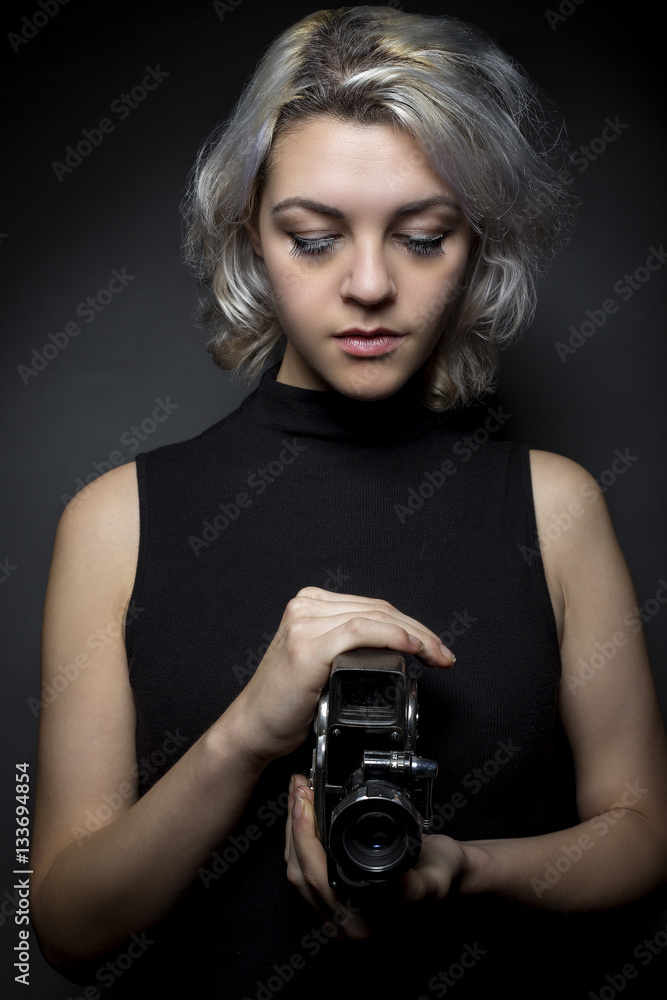 Female actor posing with a vintage camera as an artistic director ...