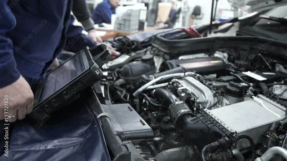 Staff updated the firmware software of the car at the station. Stock ...