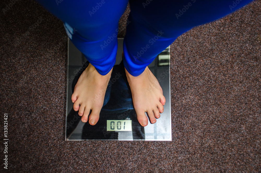 Female feet on scales Stock Photo | Adobe Stock