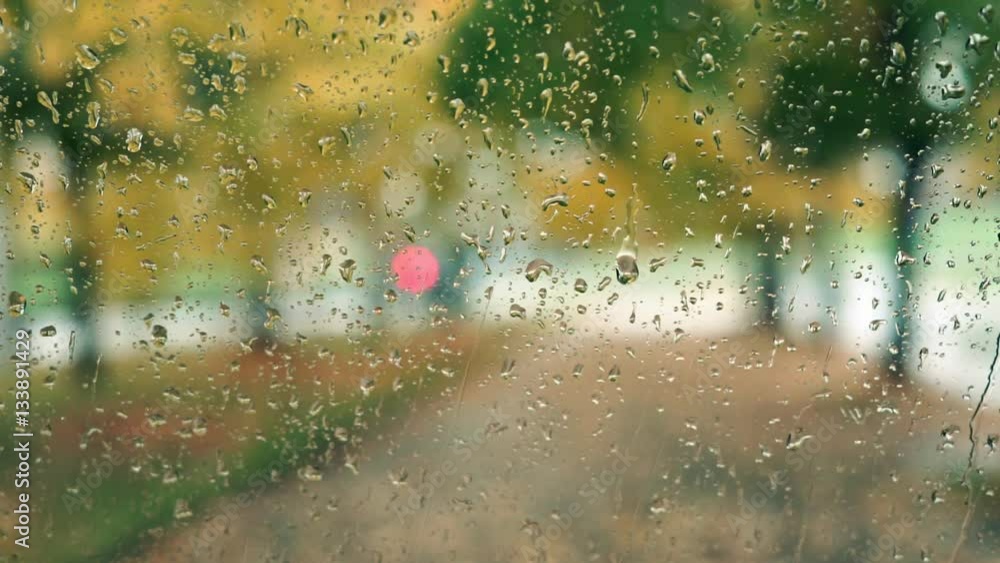 Texture windshield of the car window covered with rain drops falling on ...