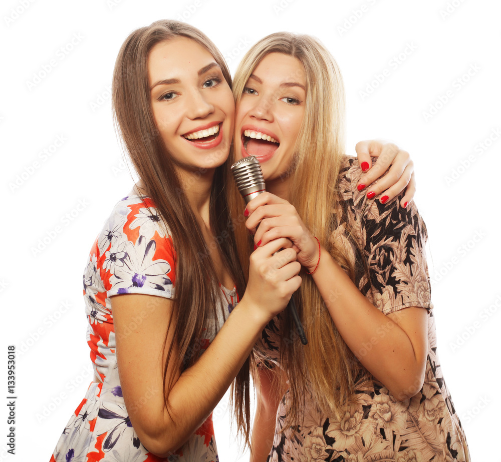 two beauty girls with a microphone singing and having fun foto de Stock ...