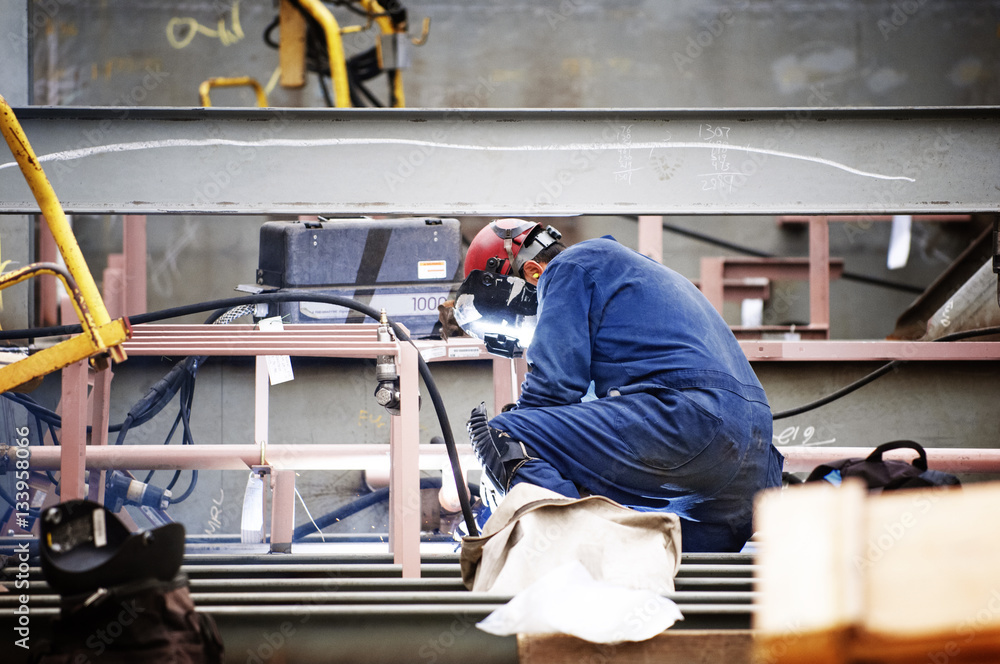 Side view of worker working at shipyard Stock Photo | Adobe Stock