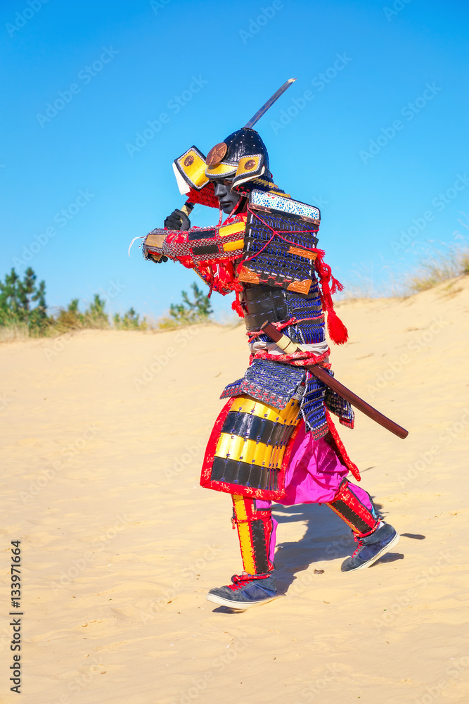 Men in samurai armour with sword running on sand Stock Photo | Adobe Stock