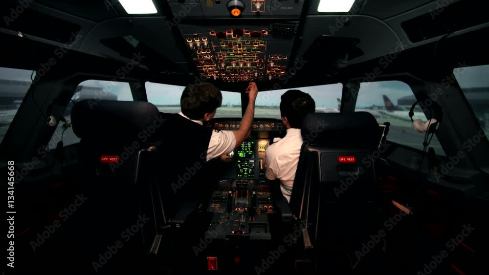Stockvideon Two caucasian male pilots in the cockpit or flight deck of ...