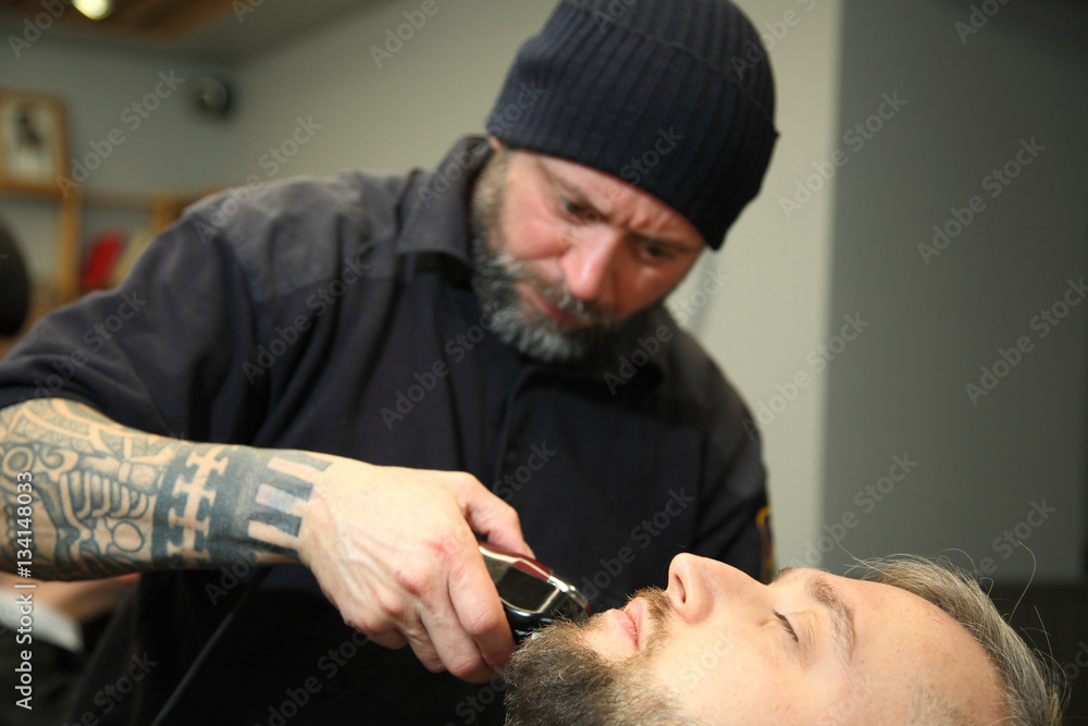 Men's hairstyling and haircutting in a barber shop or hair salon ...
