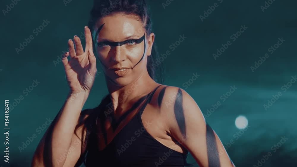 female fitness model flexes her muscles and shows her body in the pose ...