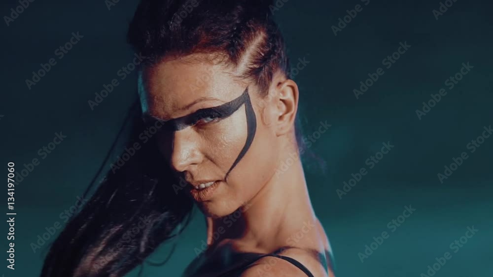 female fitness model flexes her muscles and shows her body in the pose ...