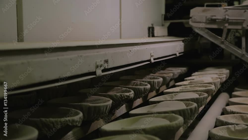 Loaf of bread on the production line in the baking industry. Making a ...