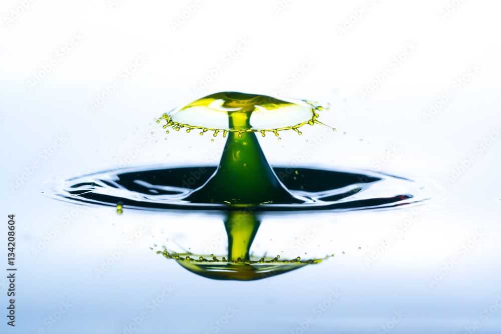 Water drop falling and drips on water mirror. Water drop splash and ...