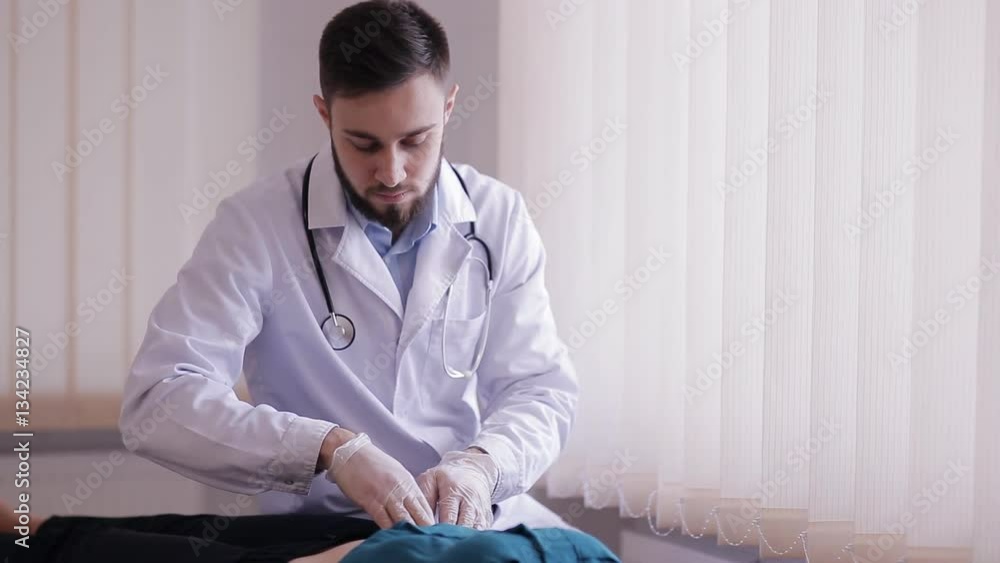 Male doctor makes palpation of the abdomen of the patient. The girl ...