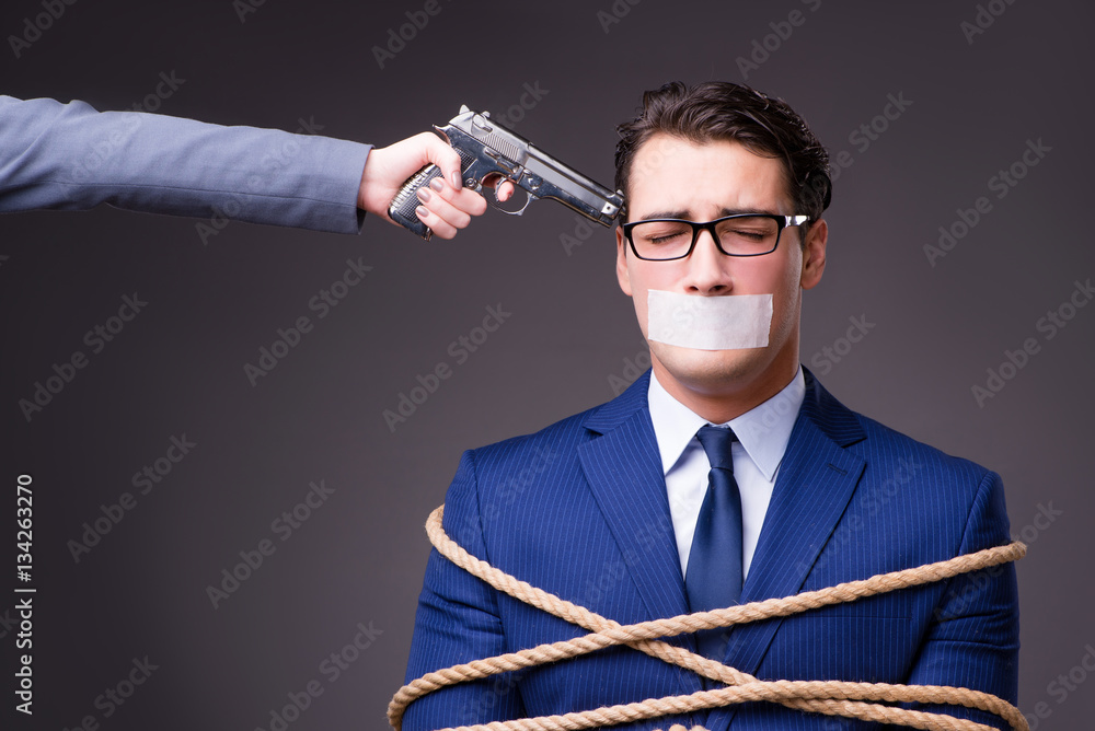 Businessman taken hostage and tied up with rope Stock-Foto | Adobe Stock