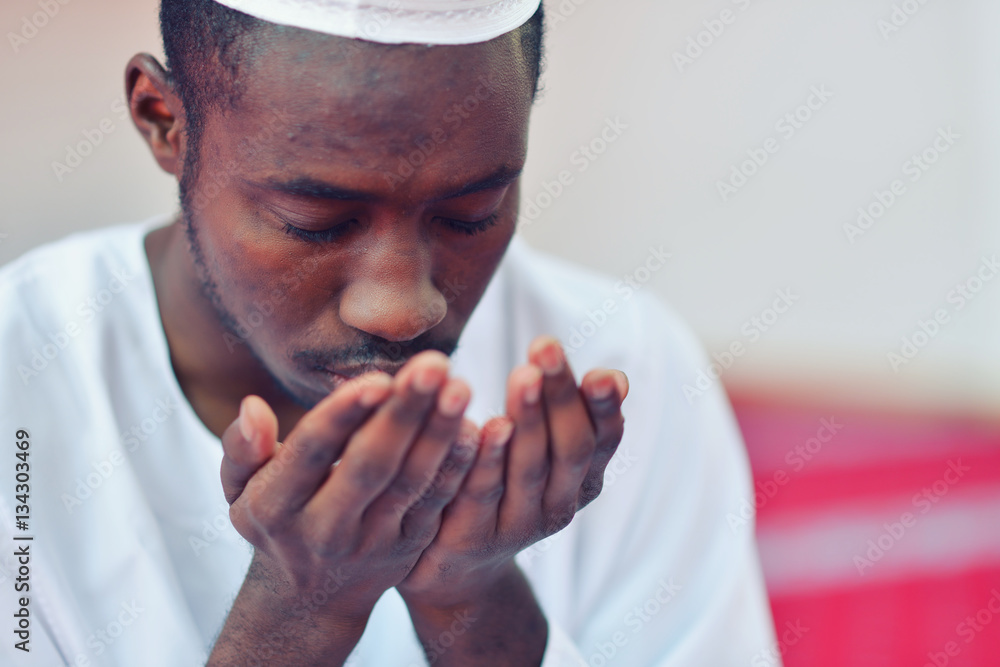 African Muslim Man Making Traditional Prayer To God While Wearing ...