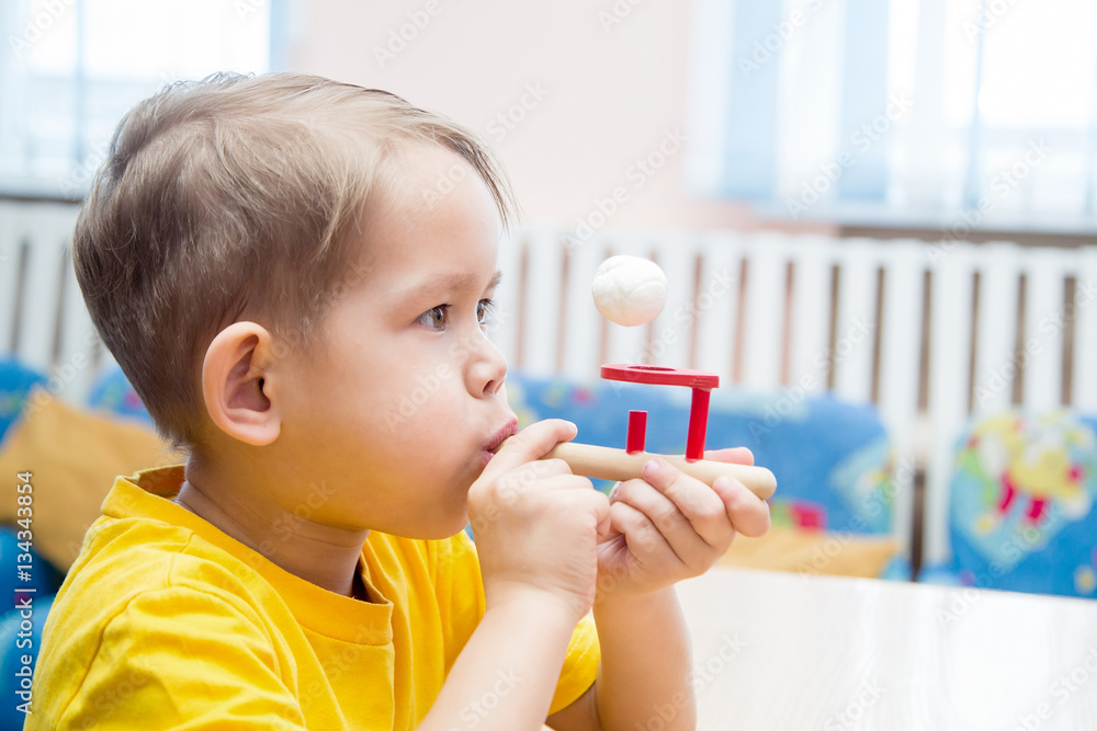 the boy uses a tool for the correction of speech lesson Stock Photo ...