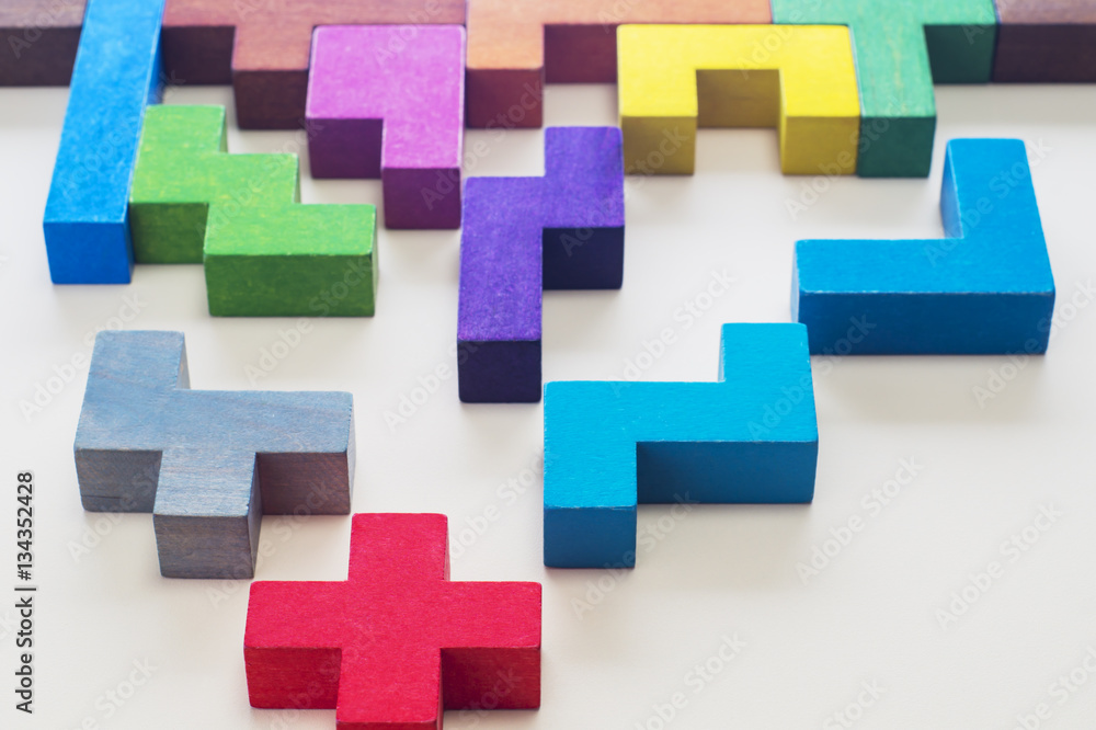 Abstract Background. Different colorful shapes wooden blocks on beige ...