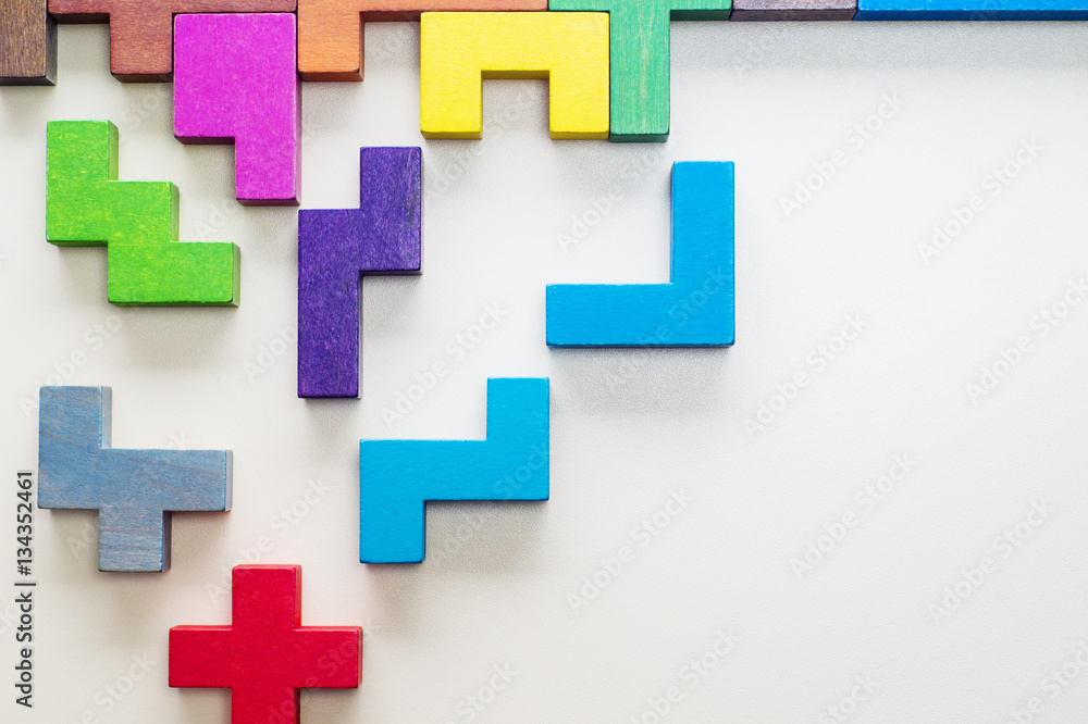 Abstract Background. Different colorful shapes wooden blocks on beige ...