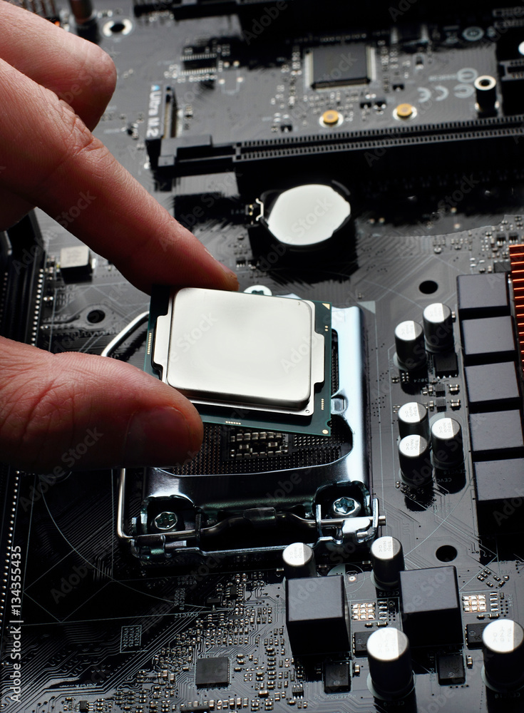 Plug in CPU microprocessor to motherboard socket. Technological background.Concept computers ...