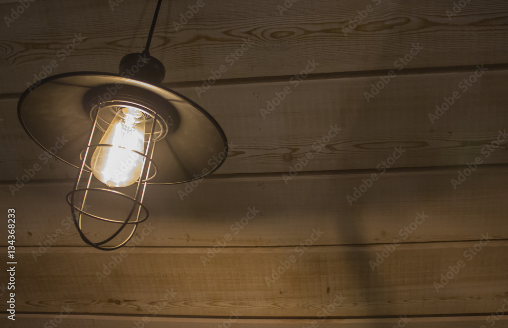 Old fashioned vintage lantern lamp burning with a soft glow light in an ...