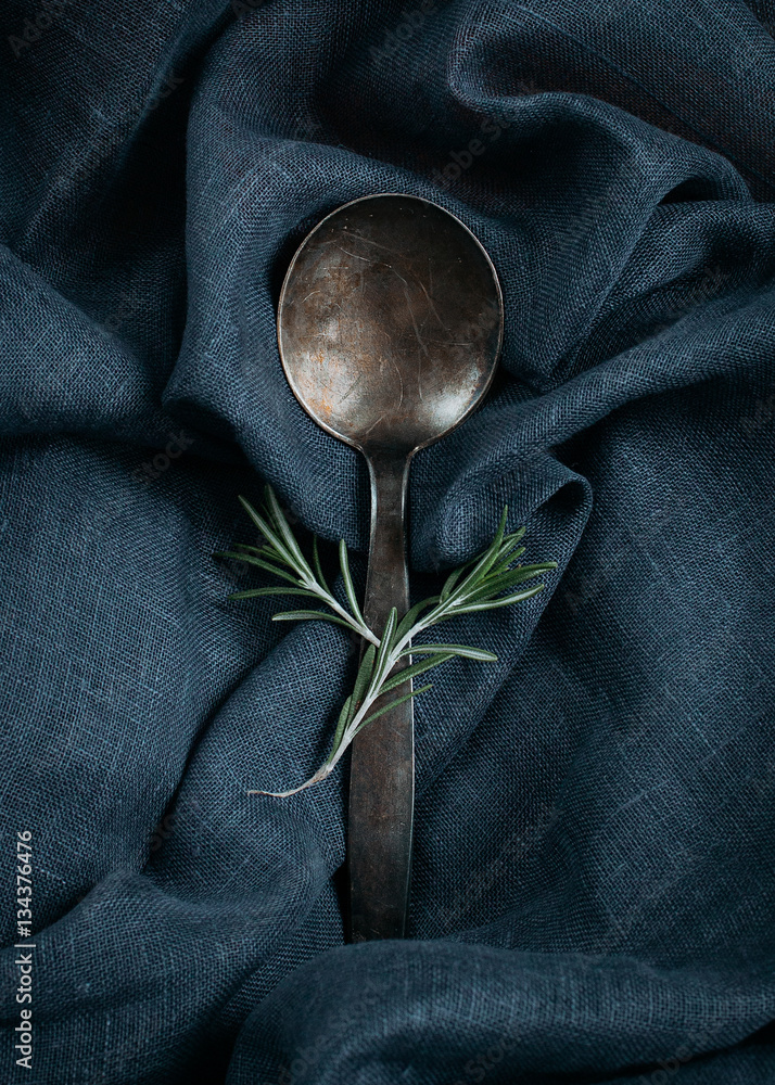 Stylish food. Silver spoon with rosemary on textile background. Stock ...