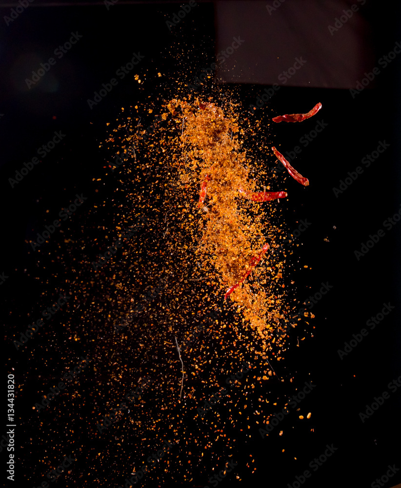 Cayenne pepper powder explosion isolated on black background Stock ...