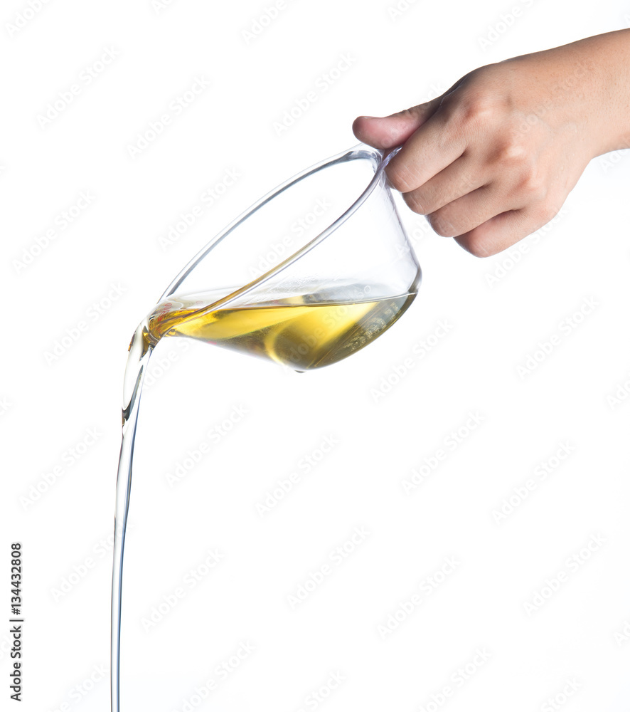 Pouring cooking oil from measuring cup isolated on white Stock Photo ...
