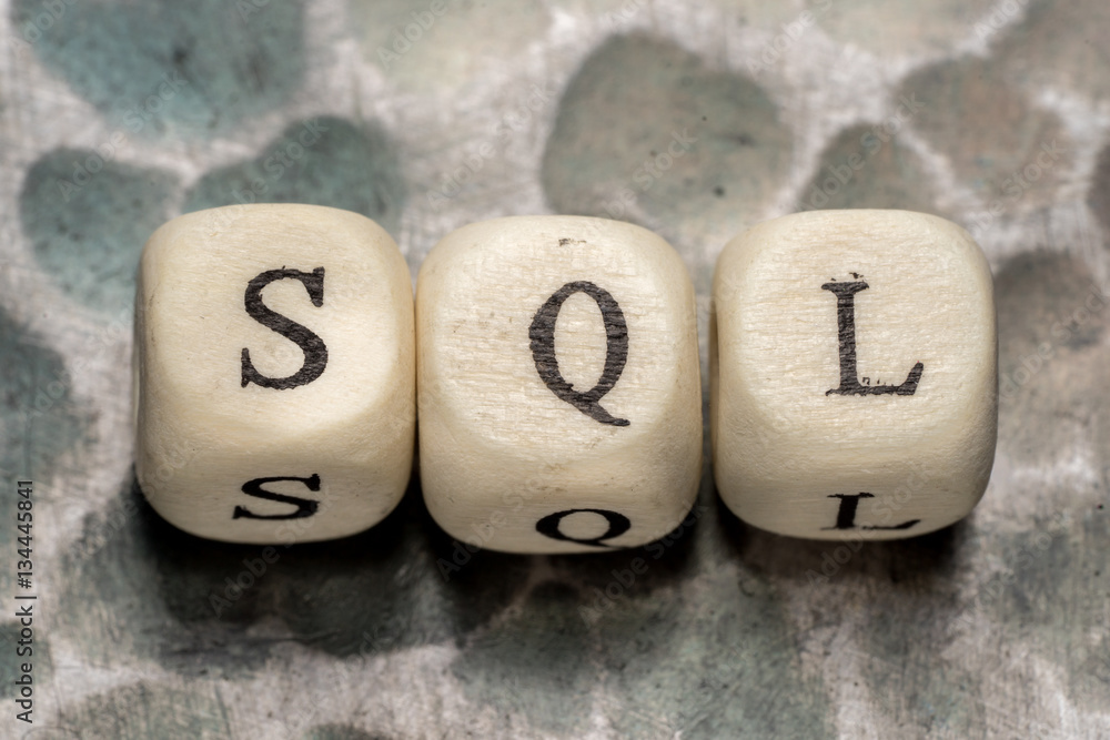 the word sql (structured query language), lined with wooden blocks on a metal forged textural ...