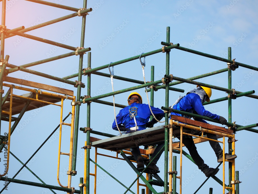 Construction workers working on scaffolding,Man Working on the Working ...