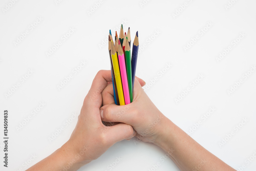 Female hand clenched in a fist dozen pencils foto de Stock | Adobe Stock